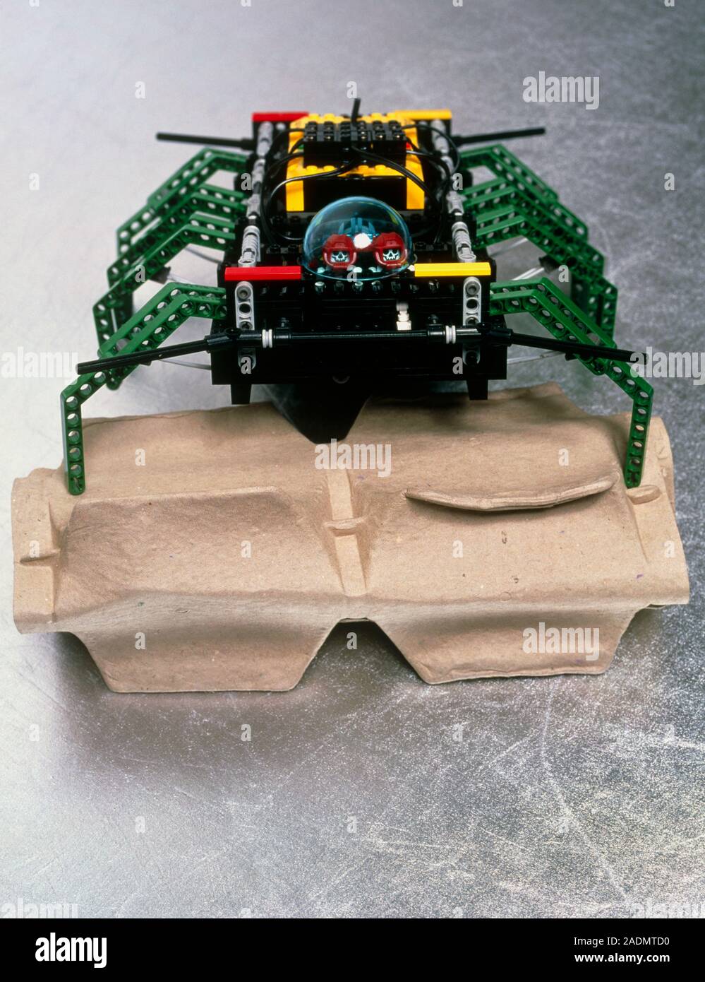 Robot spider. Lego robot spider climbing over a cardboard box. This ...