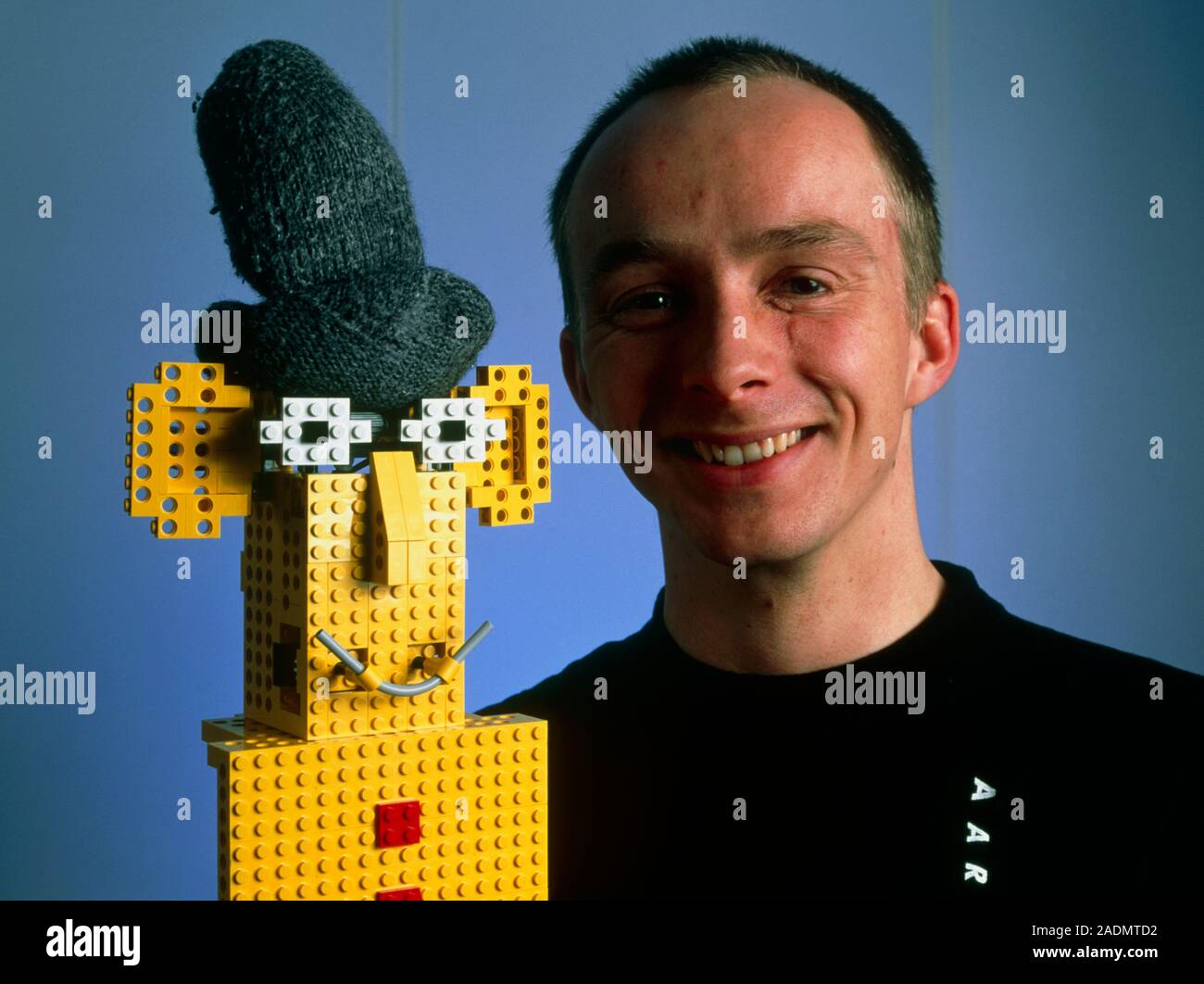 Emotional robot (image 1 of 2). Male researcher standing with the ...