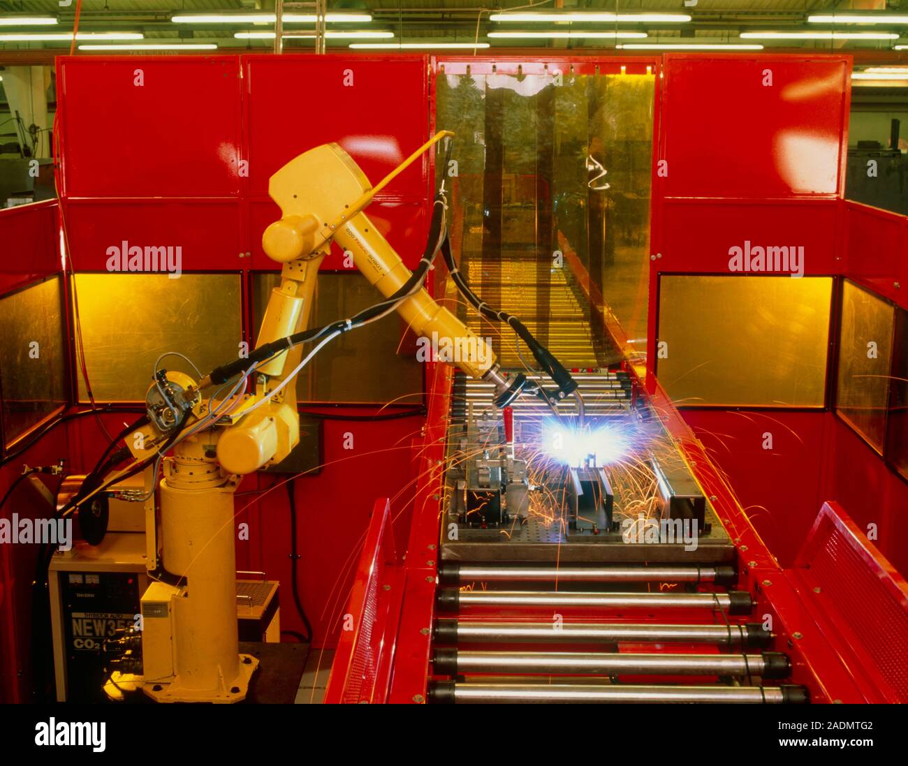 Industrial robot welding on a production line Stock Photo - Alamy