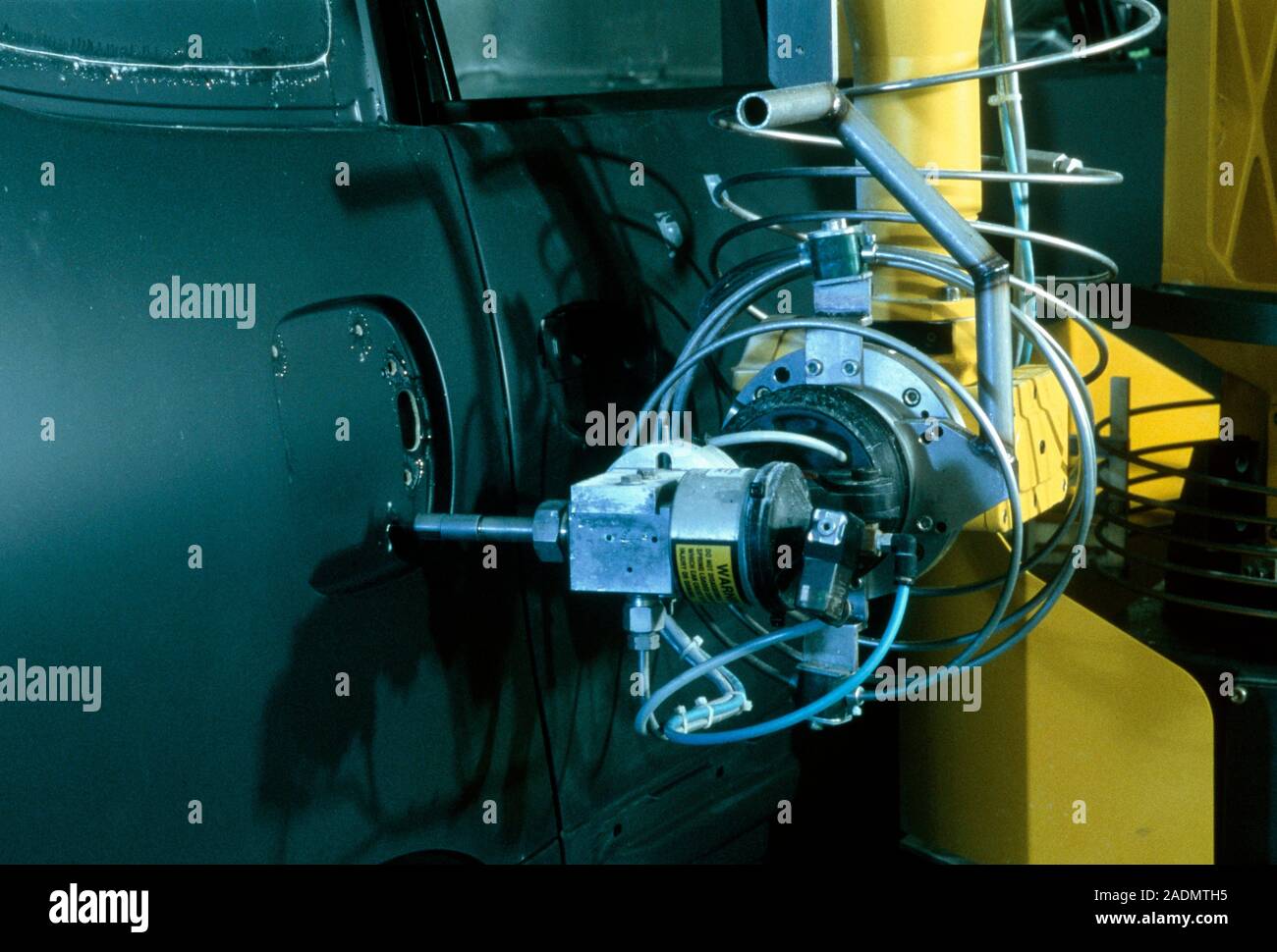 Car production robots. Computer-controlled robot arm being used in the ...