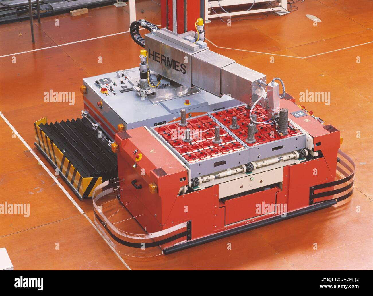 Robot co-operation. Assembly robot (with arm) and materials-handling ...