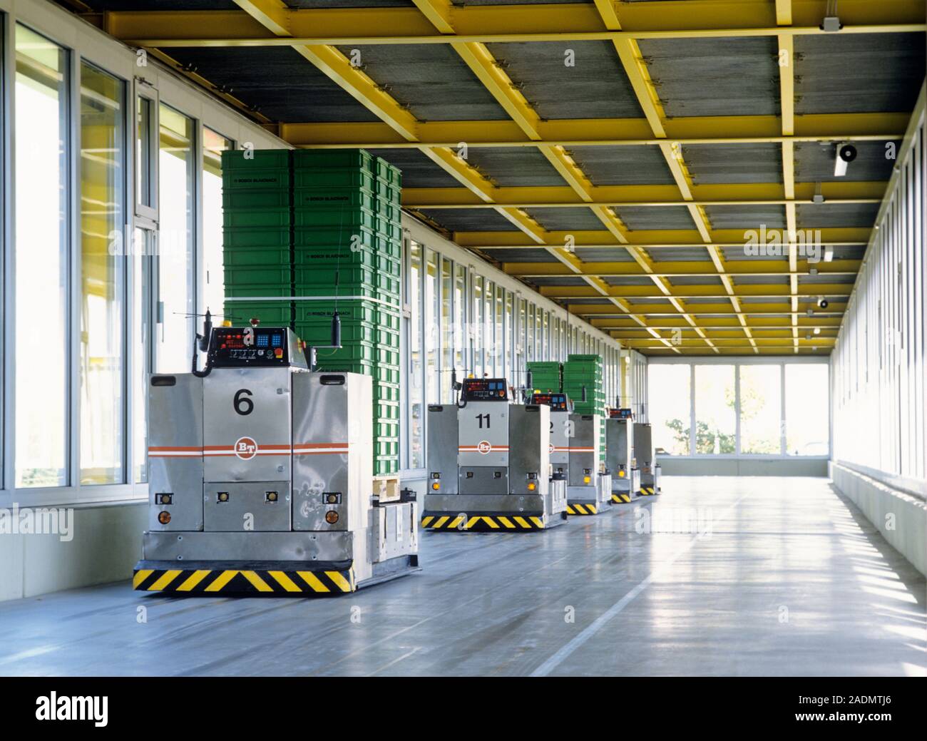 Factory robots. Automated guided vehicles (AGVs) carrying materials to ...