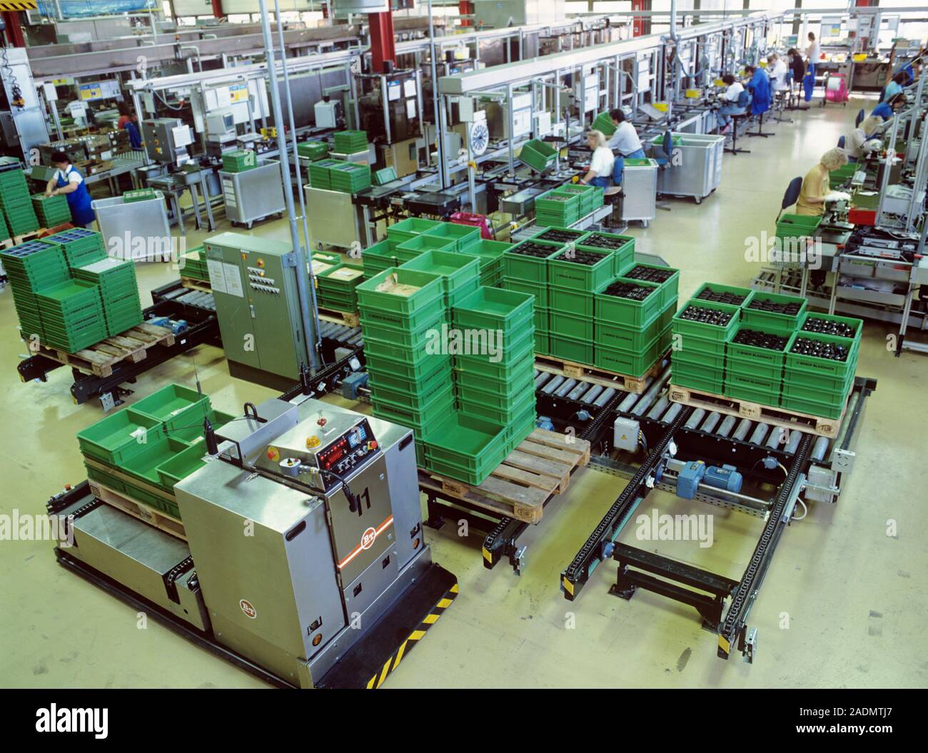 Factory robots. Automated guided vehicles (AGVs) carrying materials to ...
