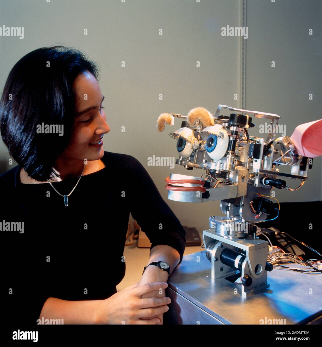 Kismet robot. Researcher Cynthia Breazeal inter- acting with Kismet, a ...