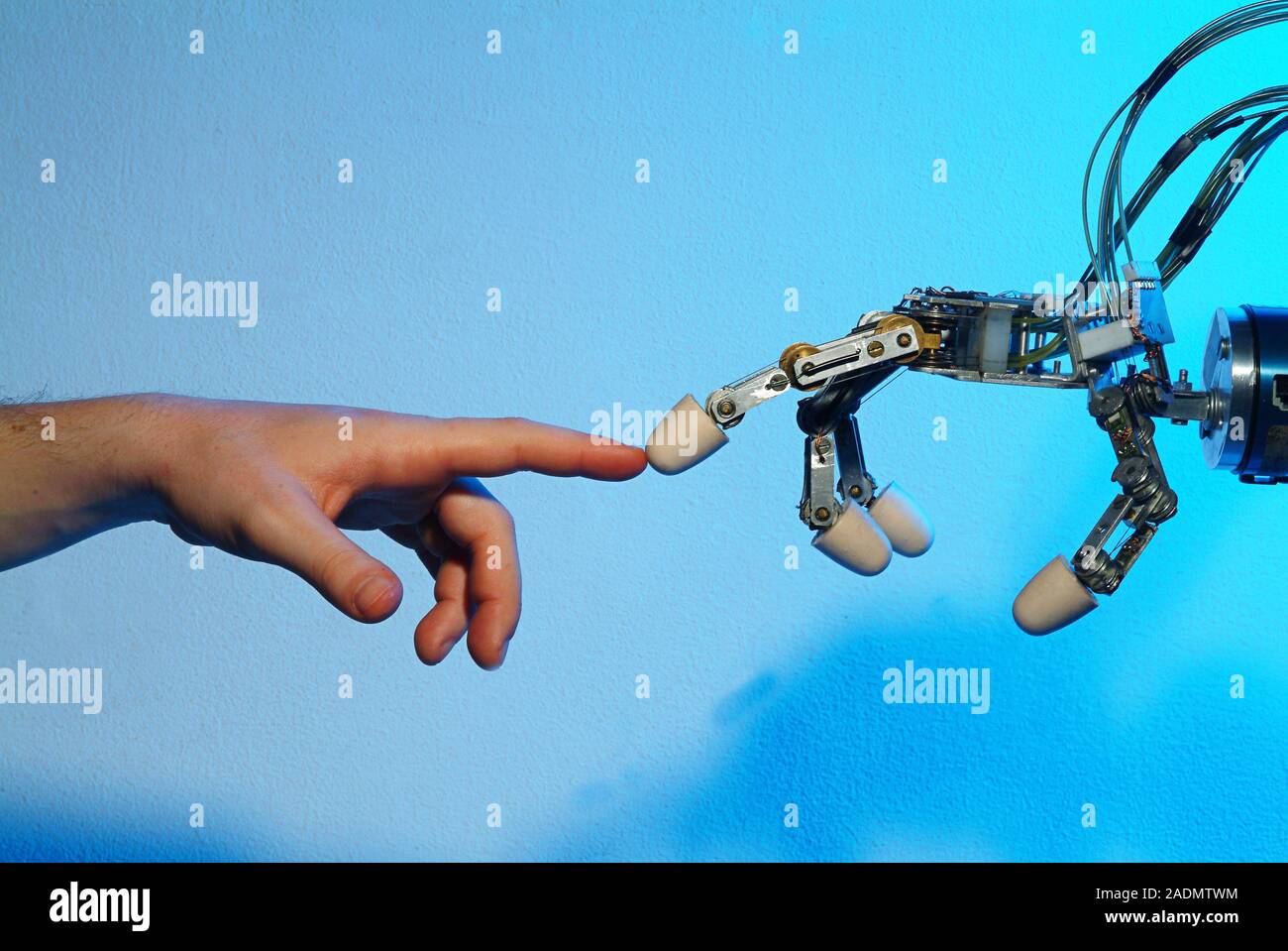 Robotic imitation. Robotic hand imitating the position of a human hand ...