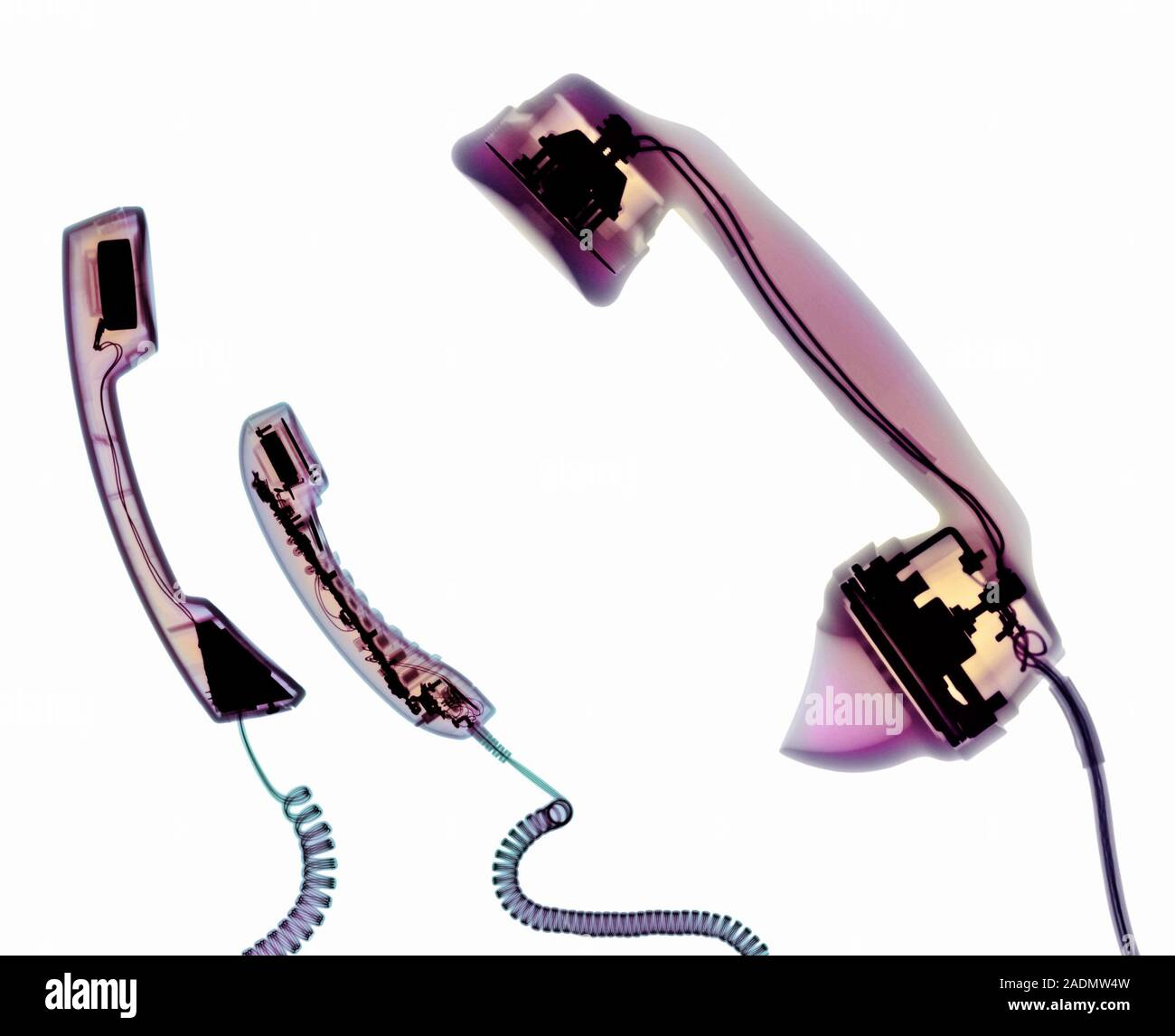 Office intimidation. Conceptual coloured X-ray of telephone handsets ...