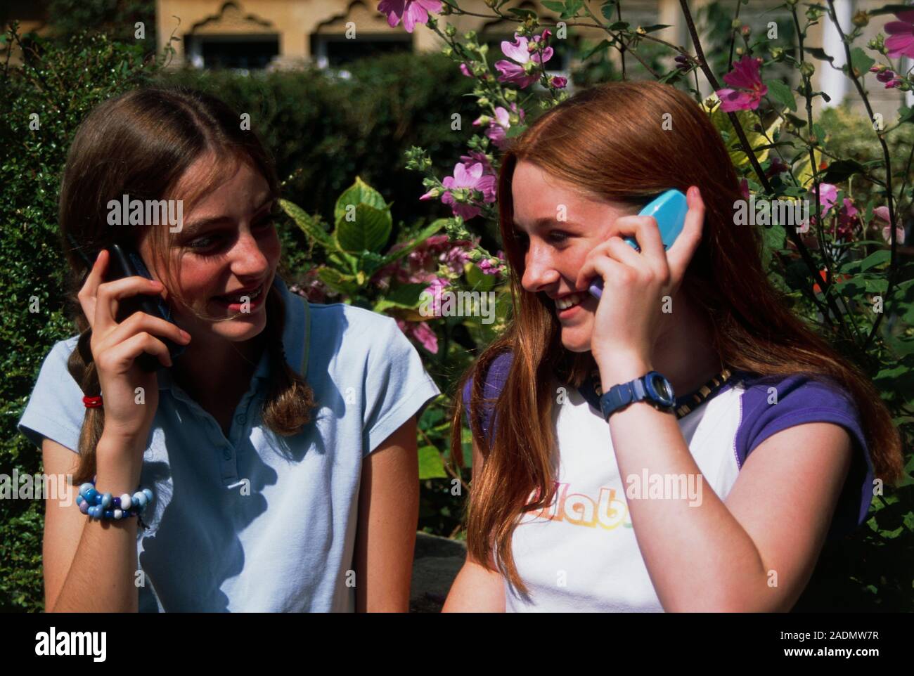 Mobile phone use. Teenage girls using their mobile telephones Stock ...