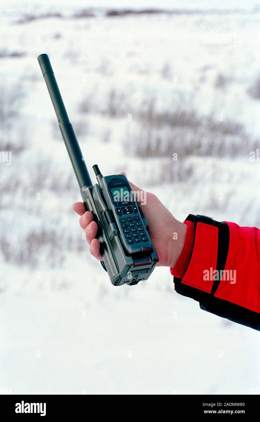 Iridium satellite phone being held in a hand. The Iridium network ...