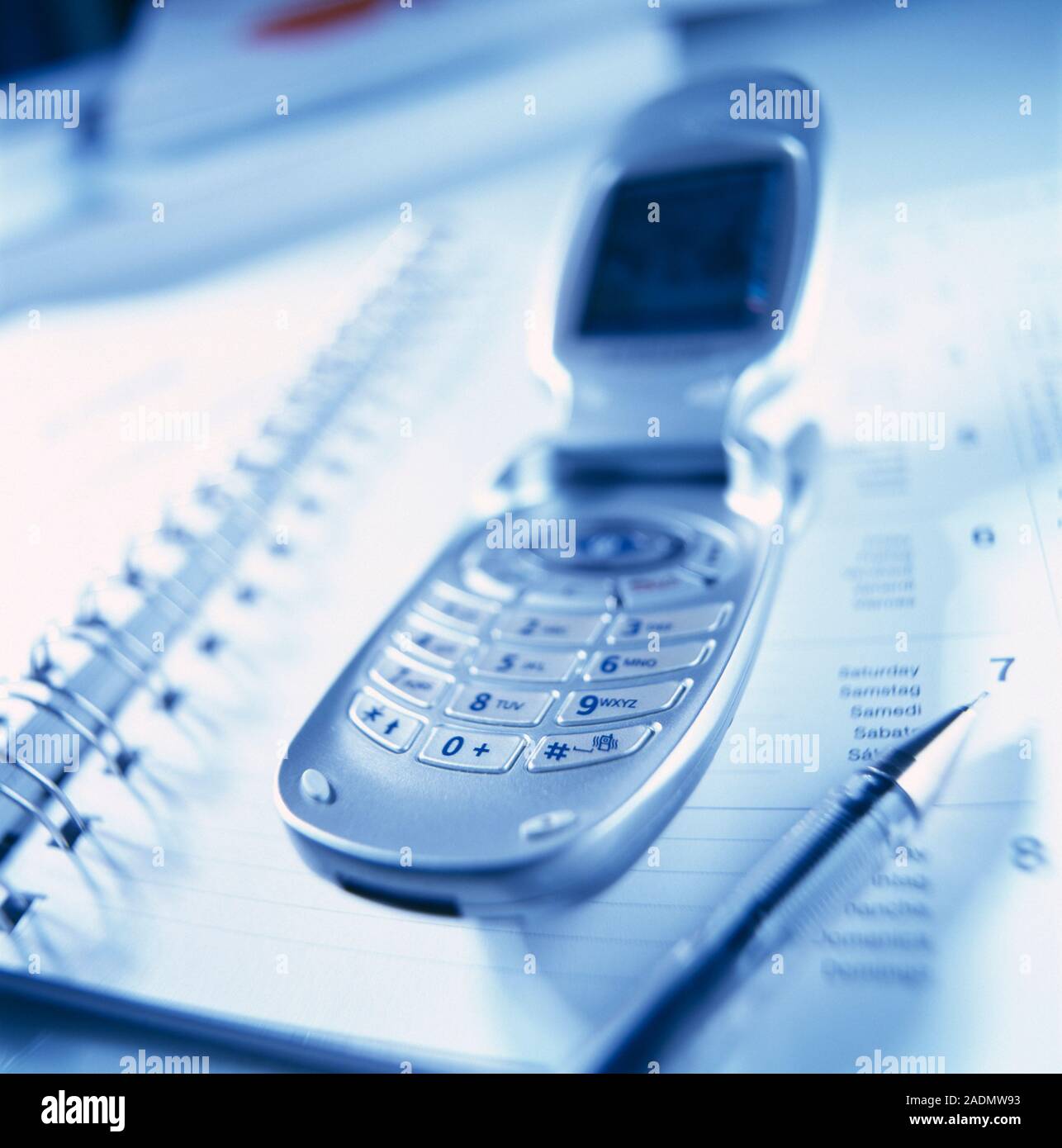 Mobile telephone. Clasp-style mobile telephone opened to show the ...