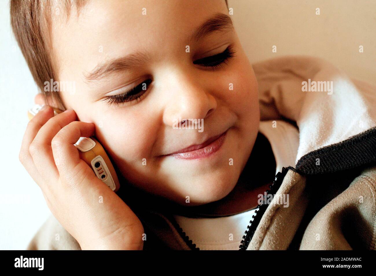 Mobile phone use. Young boy using a mobile phone Stock Photo - Alamy