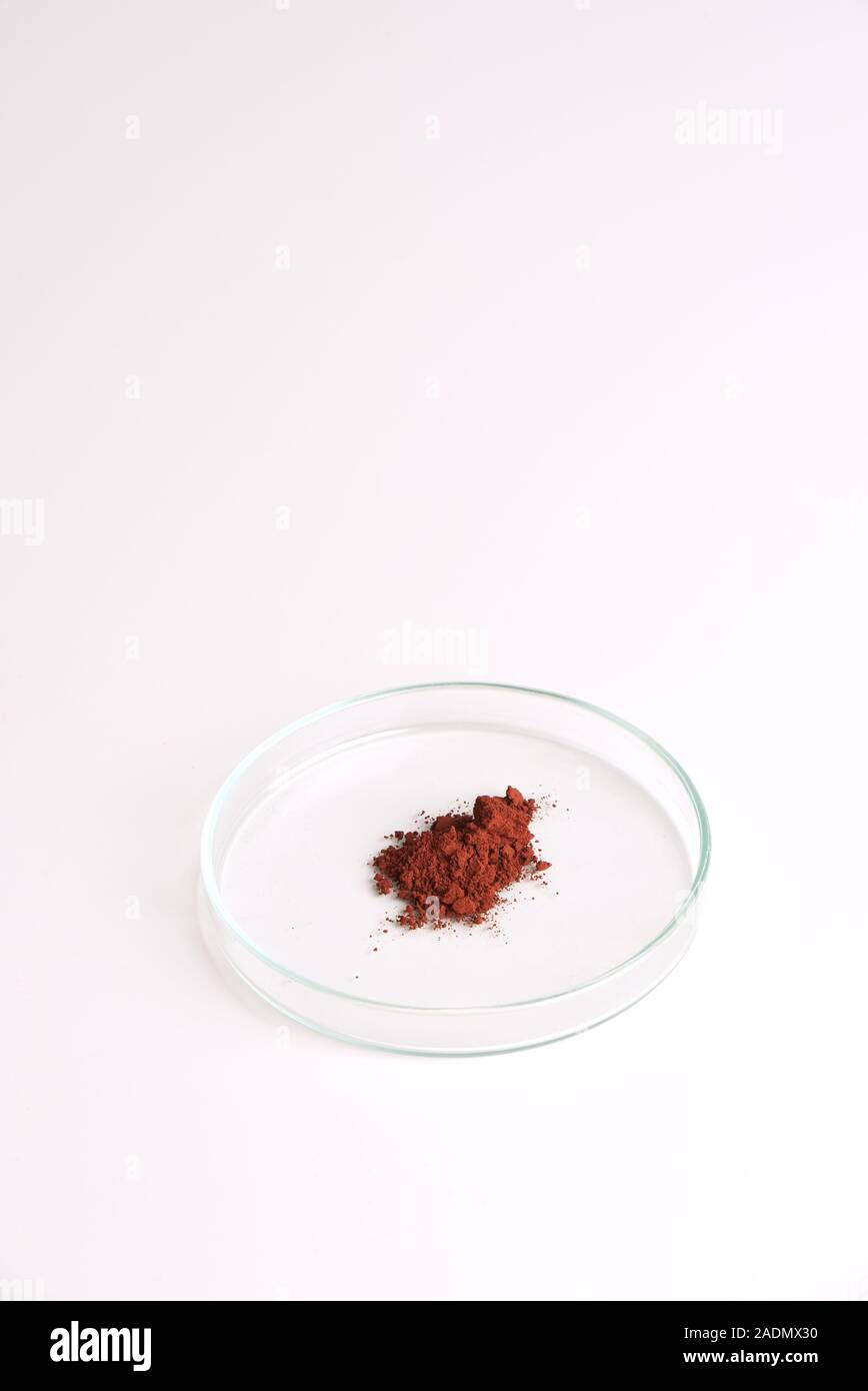 Iron III oxide powder in a glass petri dish isolated on white ...