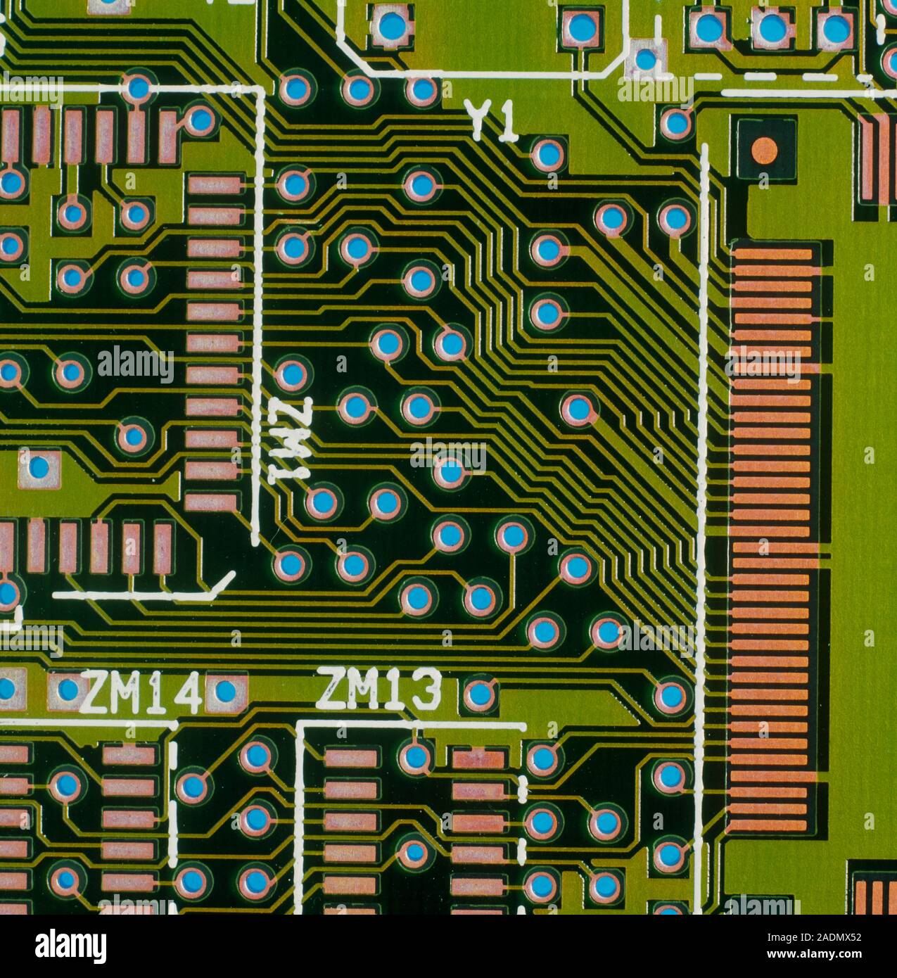Macrophotograph of the surface of a printed circuit board. The olive green areas are copper ...