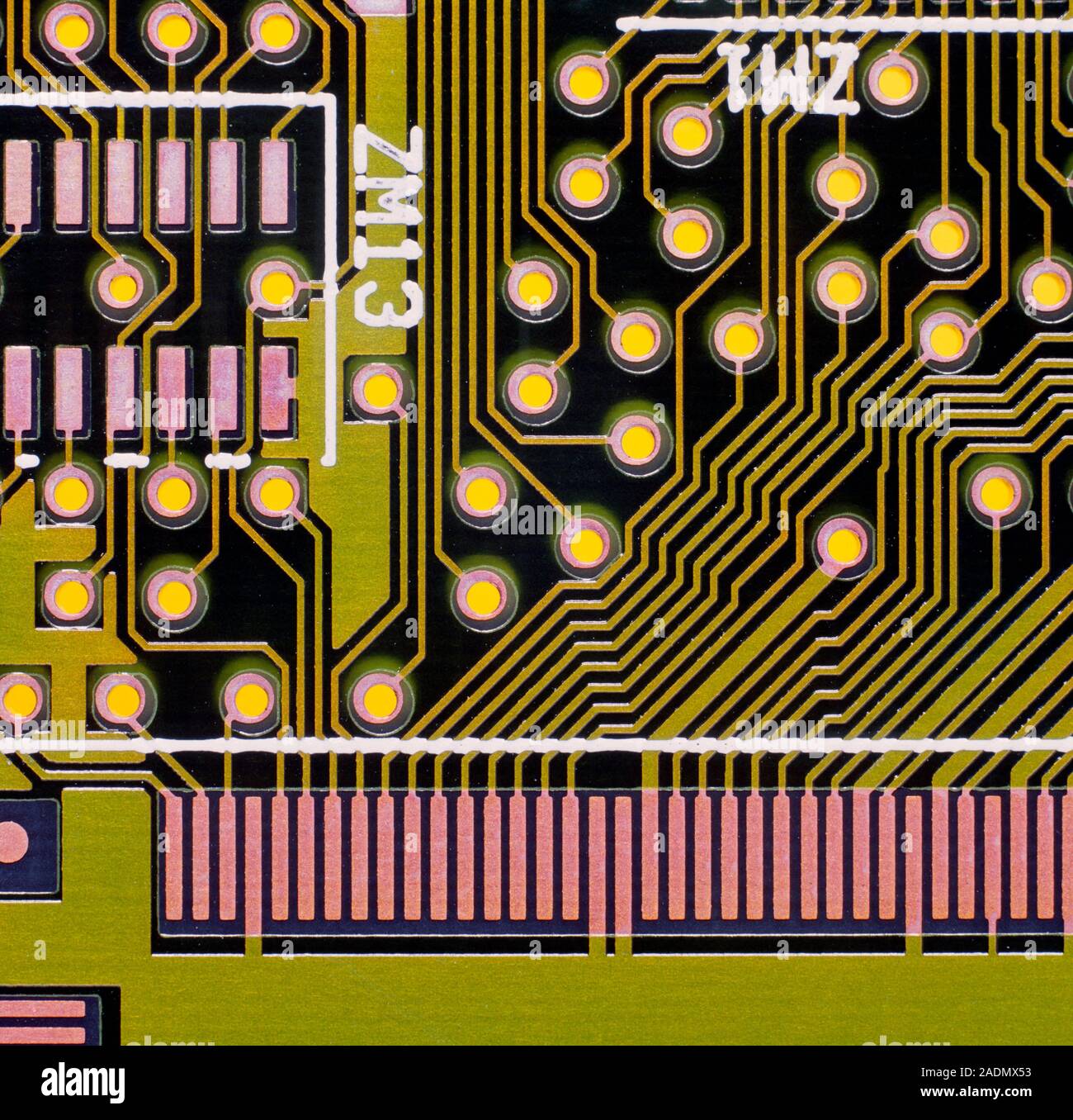 Macrophotograph of the surface of a printed circuit board. The olive green areas are copper ...