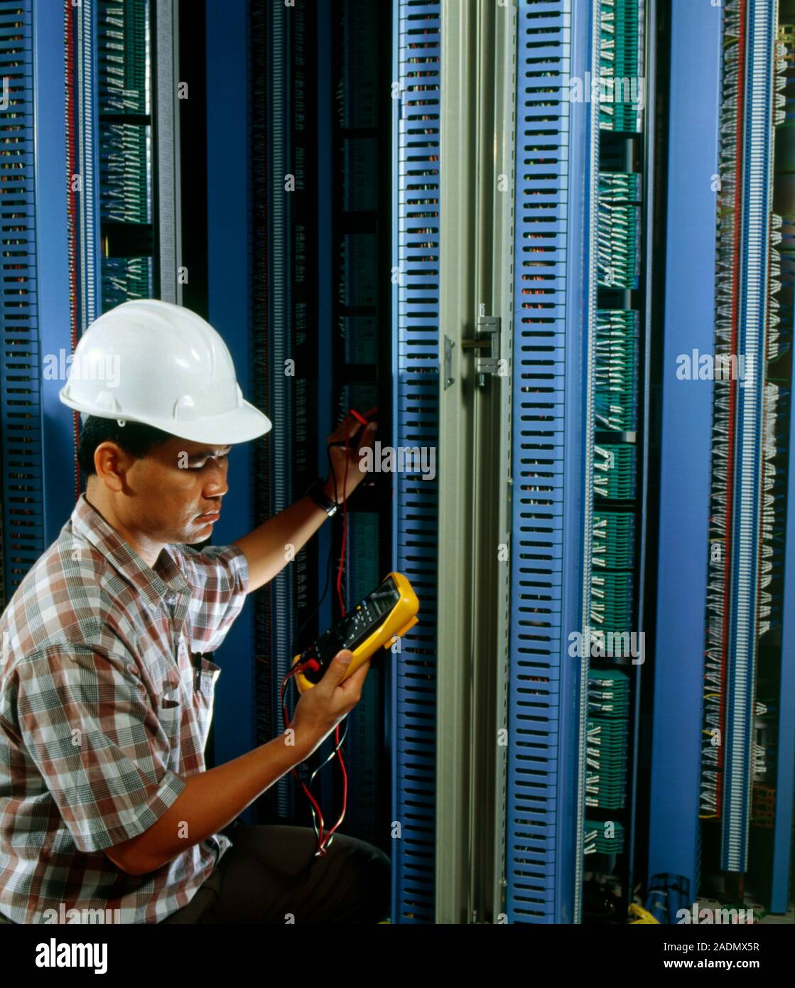 Circuit testing. An engineer checks current flow through circuit boards ...