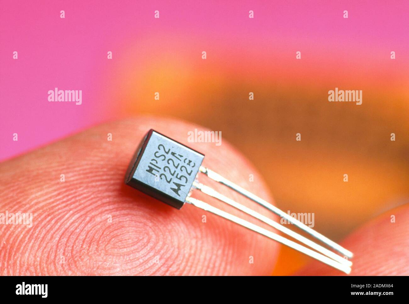 Transistor. Transistor from the late 1990s rests on a fingertip ...