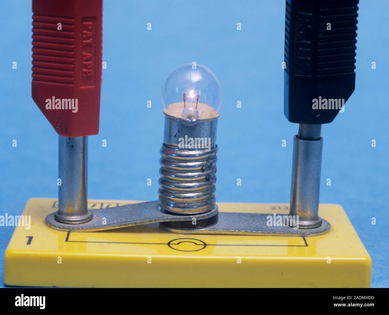 Light bulb. Part of an electrical circuit with a small lit light bulb ...