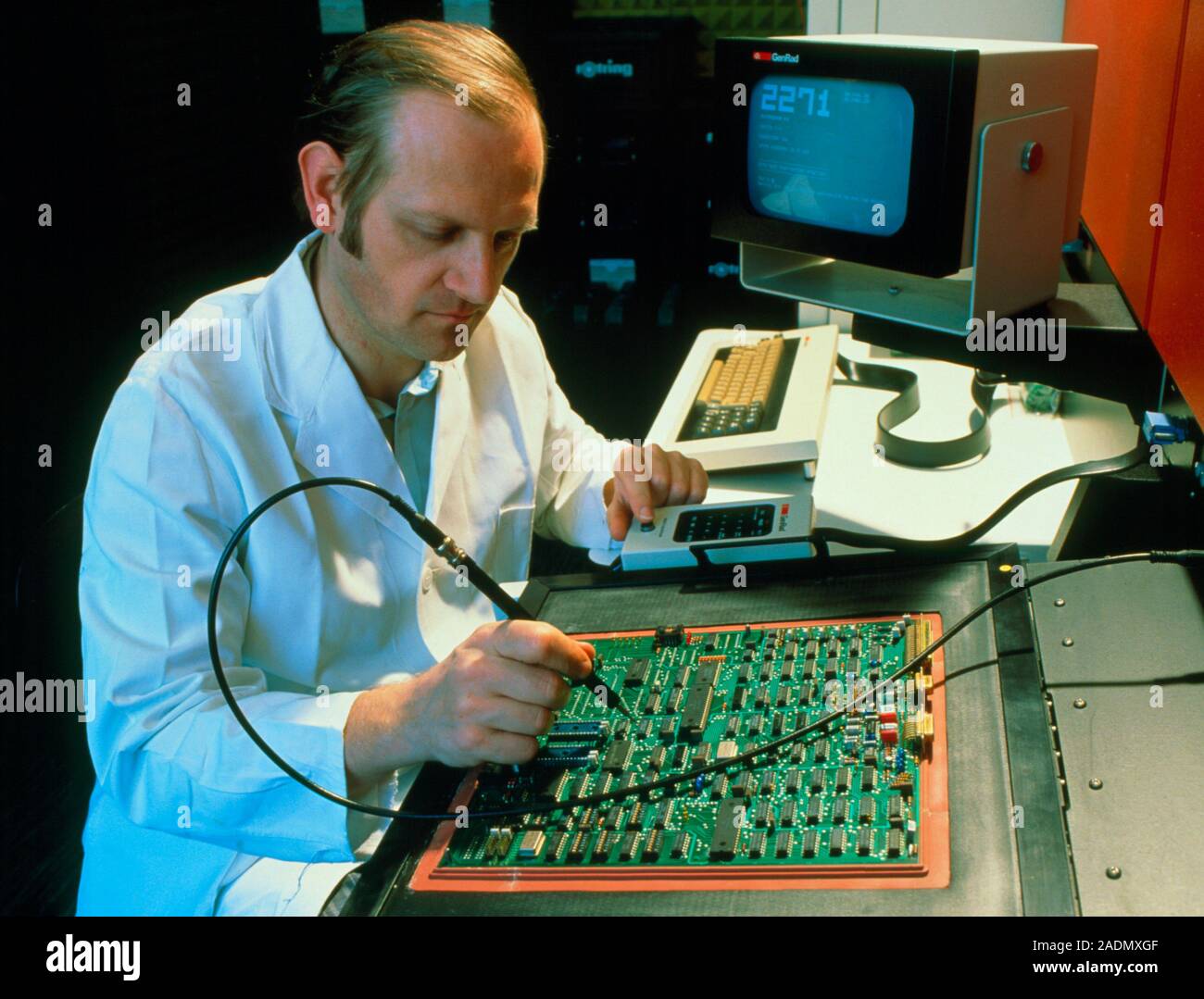 Circuit board test. Technician testing a printed circuit board. The ...