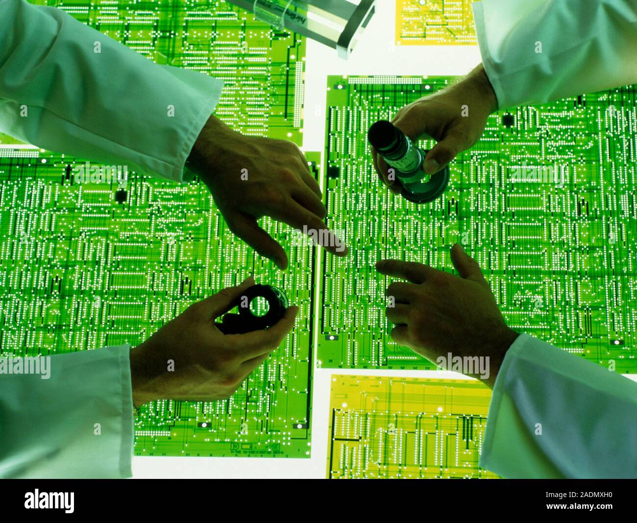 Circuit board check. Technicians visually check the quality ...