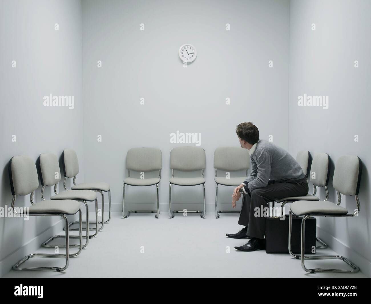 MODEL RELEASED. Job interview. Candidate sitting in a chair awaiting an ...