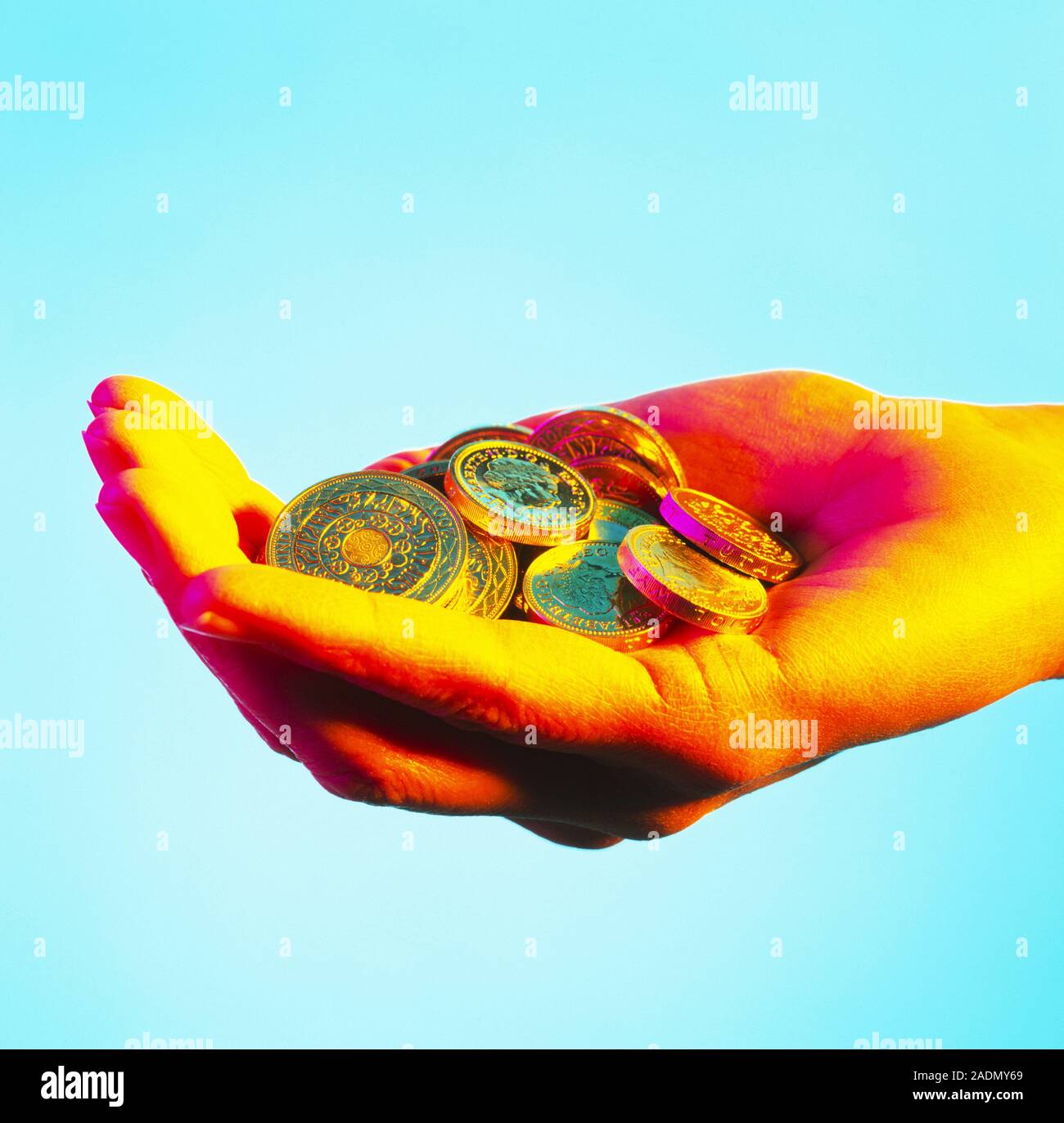 British currency. One and two pound coins in a hand Stock Photo - Alamy