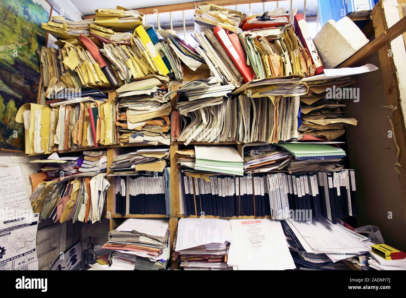 Disorganised paperwork on shelves in an office Stock Photo - Alamy