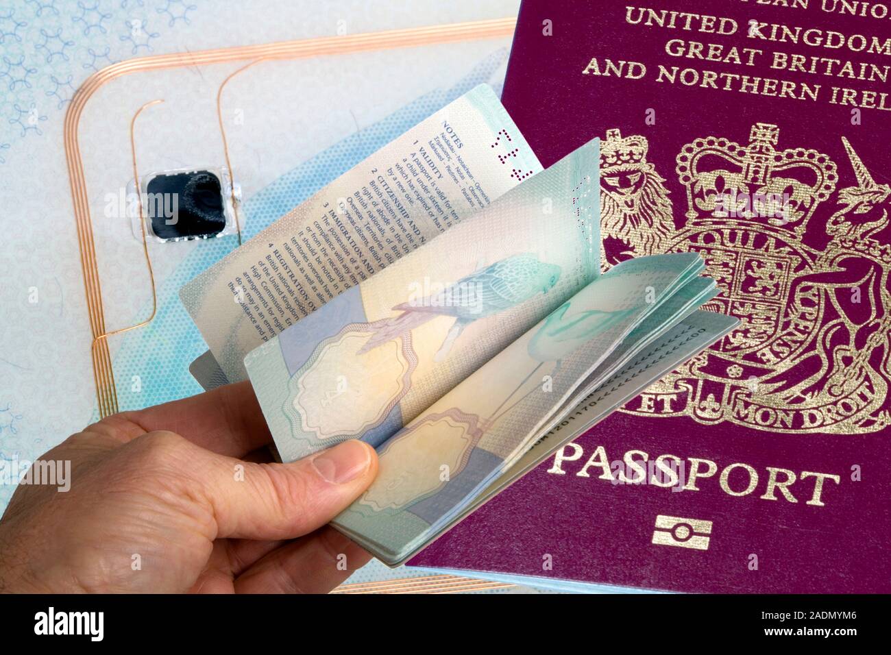 Hand holding a British passport containing a biometric chip Stock Photo ...