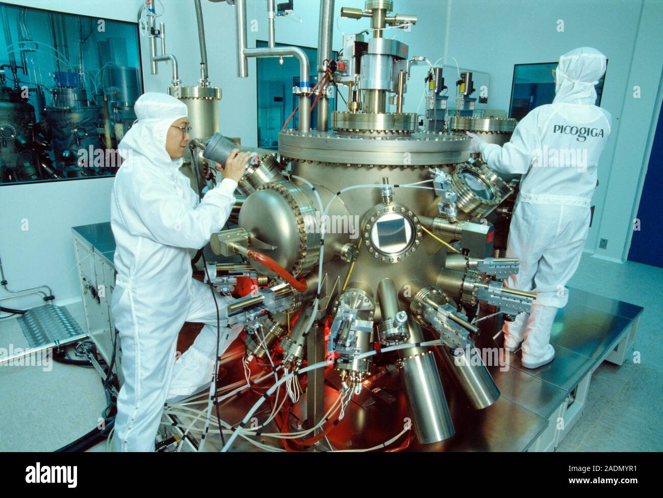 Semiconductor industry. Technicians working with equipment for making ...
