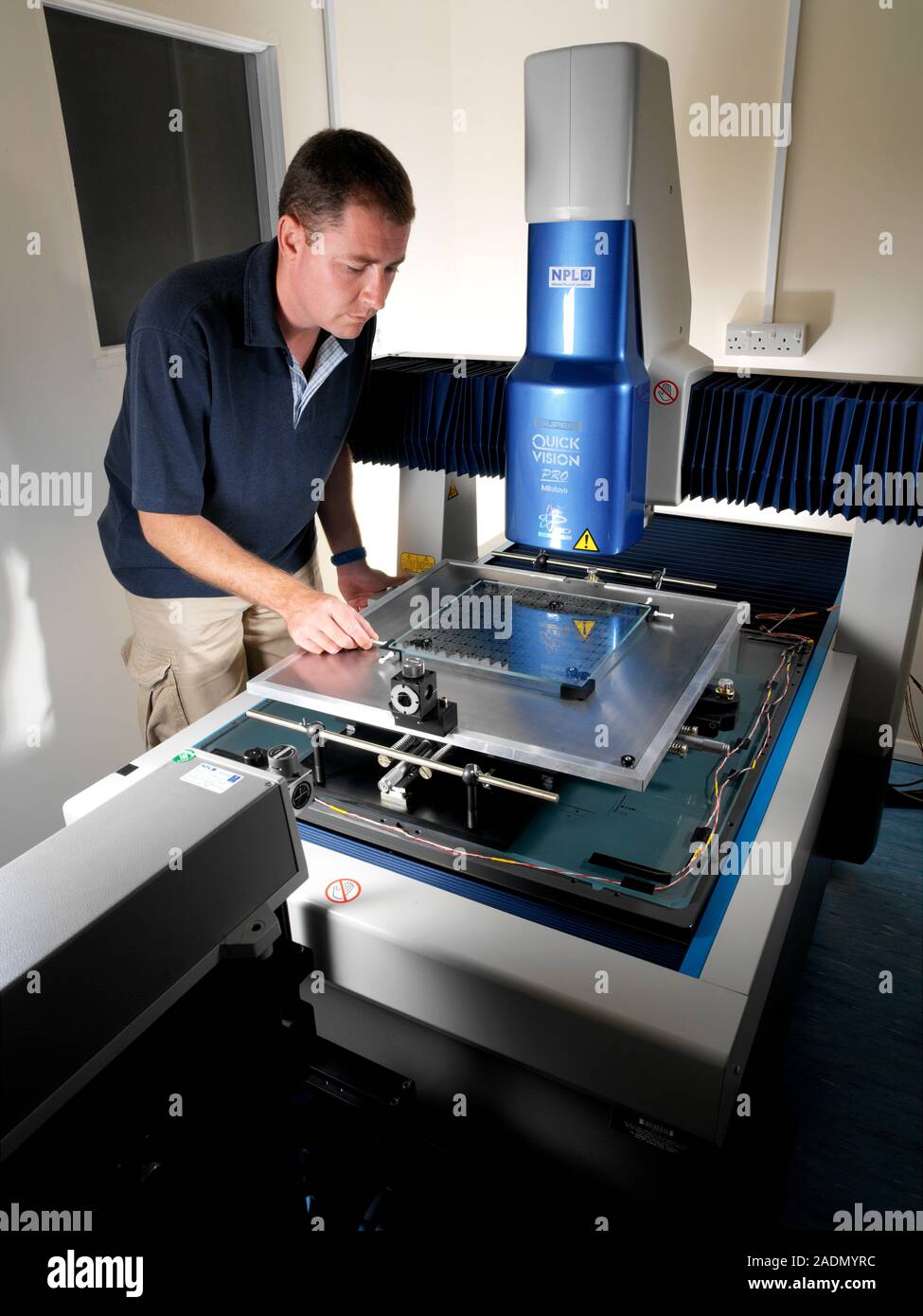 Circuit board quality control calibrator. Physicist adjusting a ...