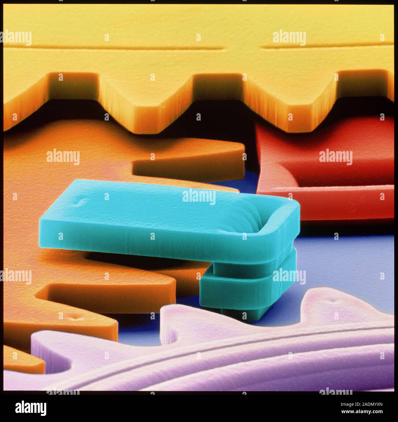 Microgears. Coloured scanning electron micrograph (SEM) of an ...