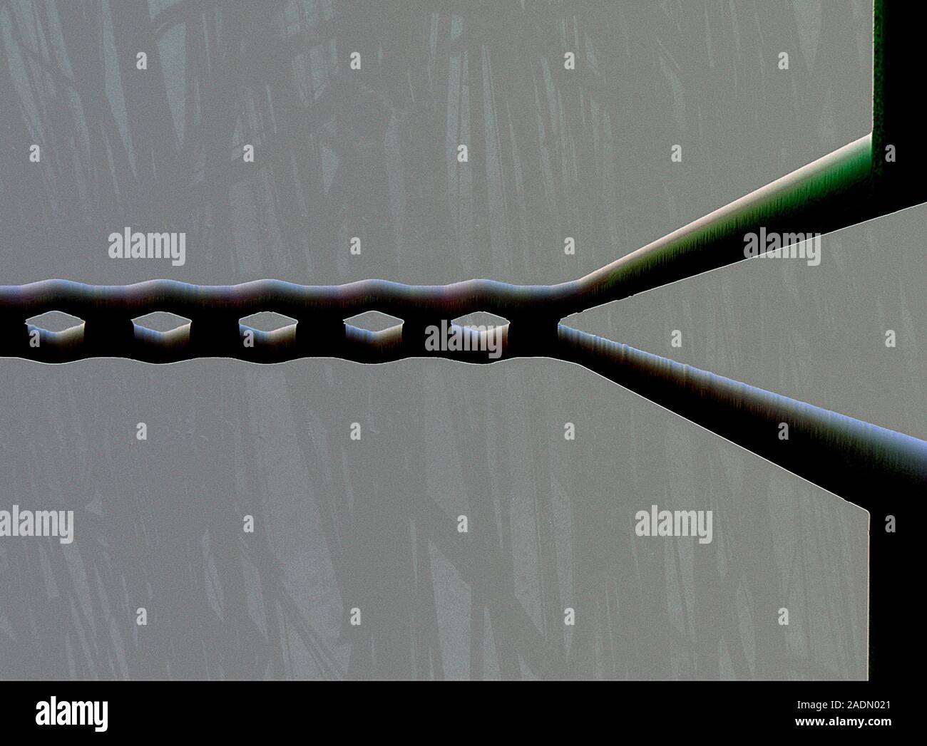 Microfluidic chip. Coloured scanning electron micrograph (SEM) of the ...