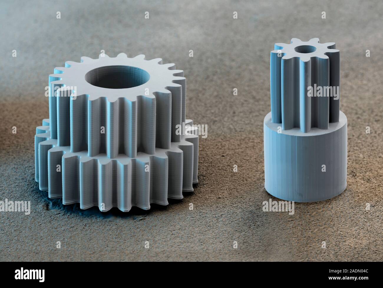 Micromechanical gears. Coloured scanning electron micrograph (SEM) of ...