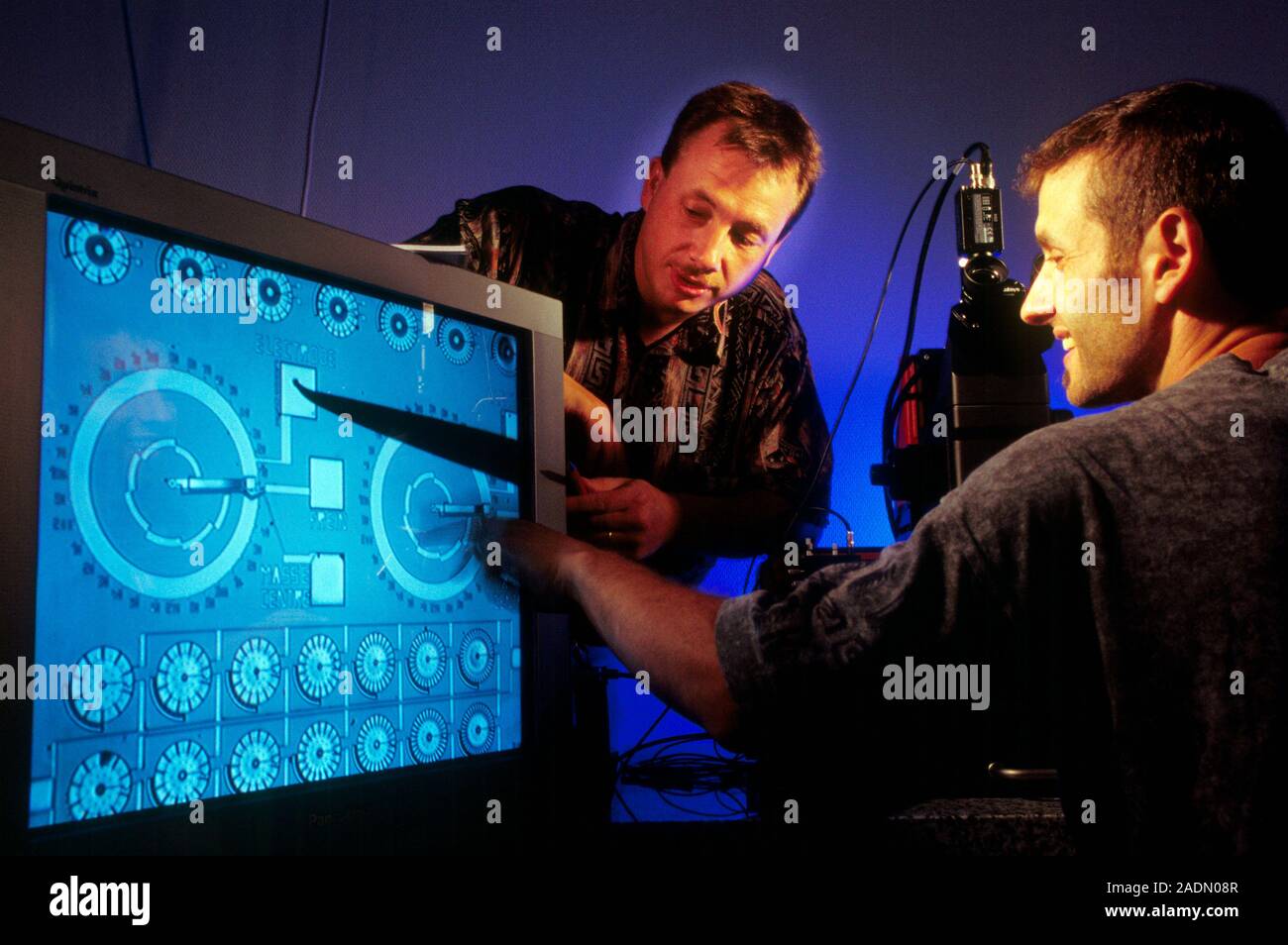 MEMS microscopy. Researchers examining a scanning electron micrograph ...