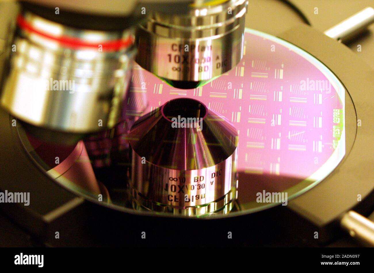 MEMS production. Light microscope being used to examine a silicon MEMS ...