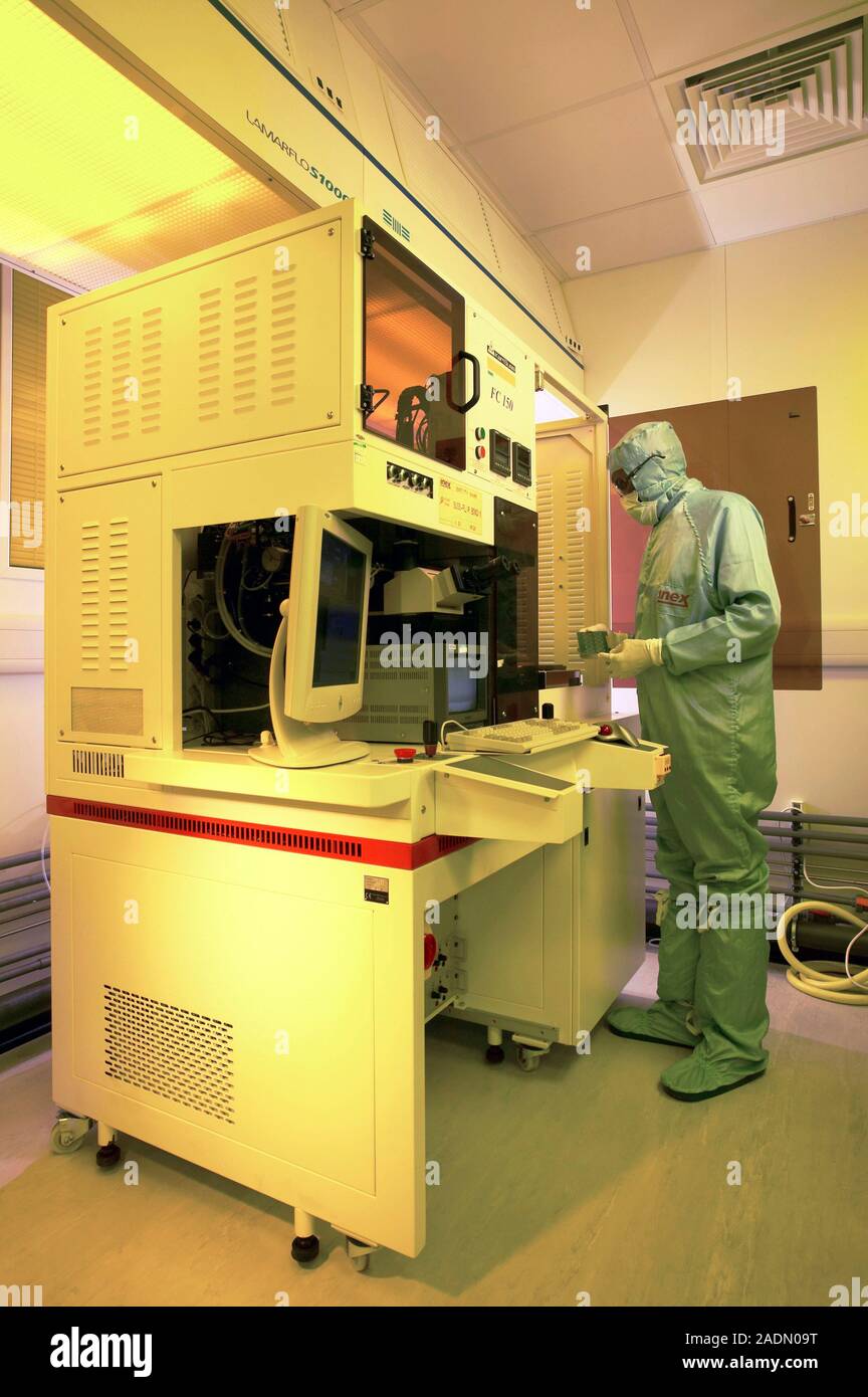 MODEL RELEASED. MEMS production. Clean room technician using flip chip ...