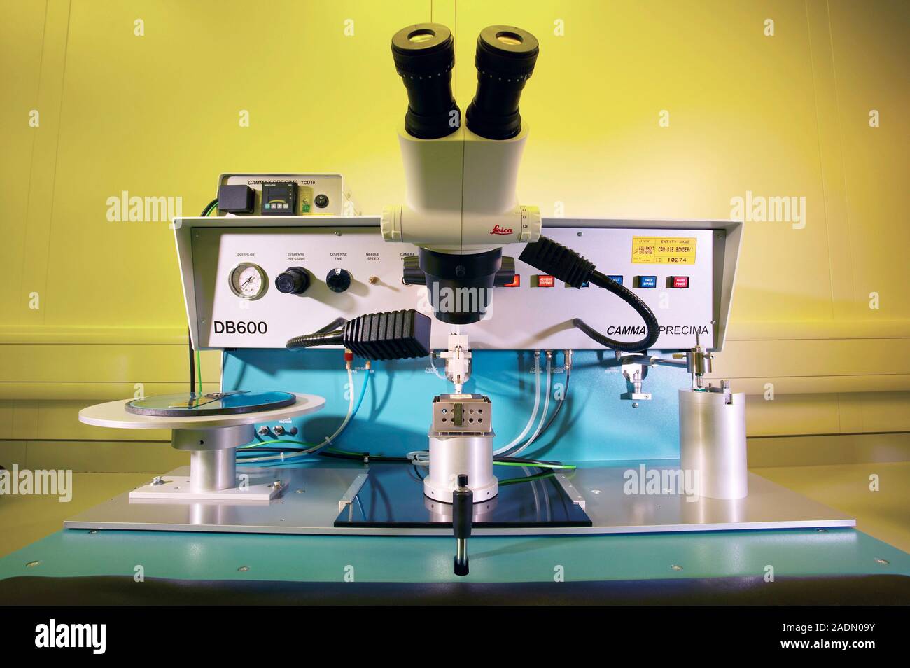 MEMS production. Microscope apparatus being used to mount MEMS ...