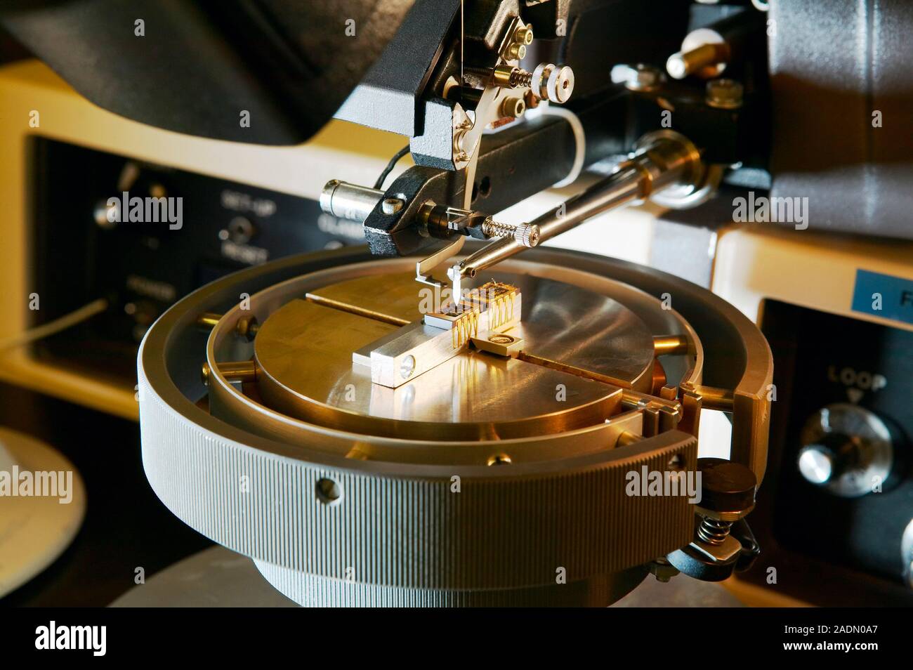 MEMS production. Bonding machine and microscope being used to add the ...