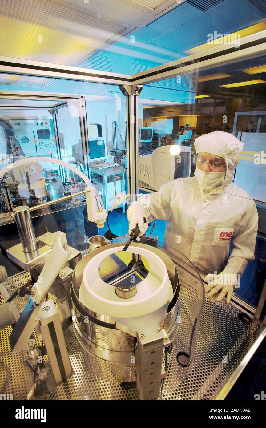 MODEL RELEASED. MEMS production. Clean room technician using ...