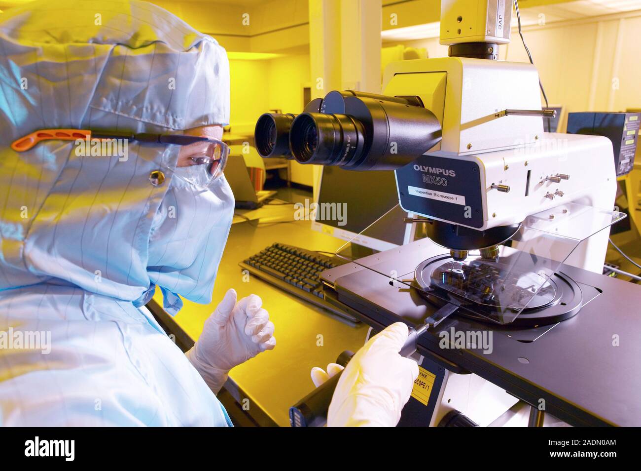 MODEL RELEASED. MEMS production. Clean room technician using a ...