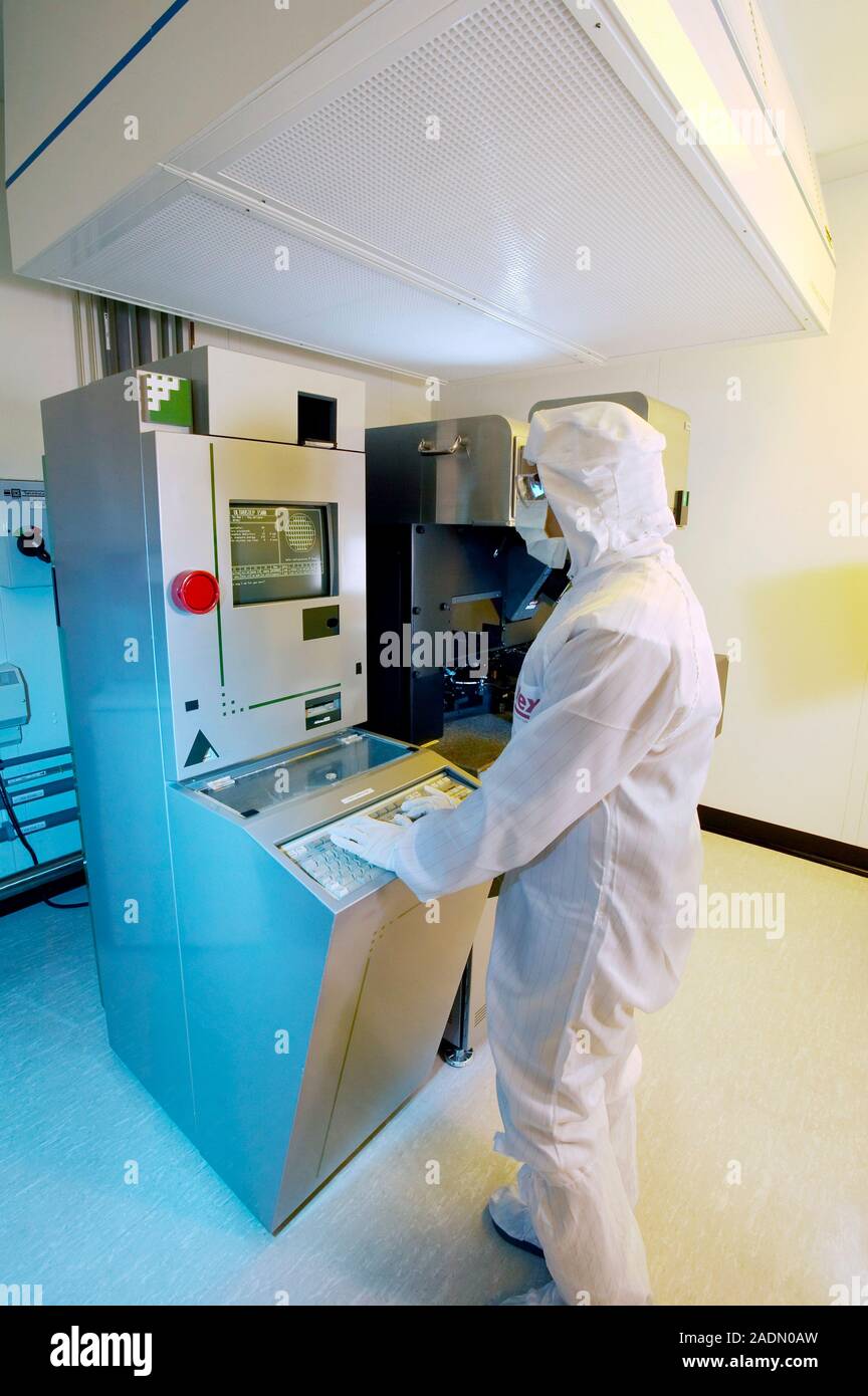 MODEL RELEASED. MEMS production. Clean room technician using a ...