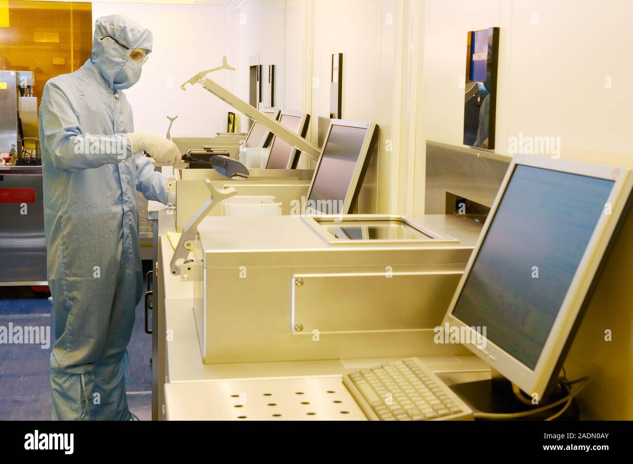 MODEL RELEASED. MEMS production. Clean room technician using a plasma ...