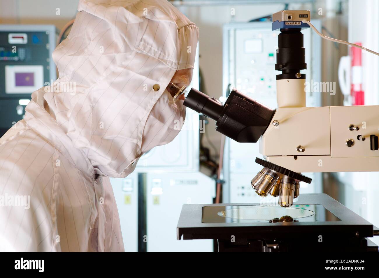 MODEL RELEASED. MEMS production. Clean room technician using a ...