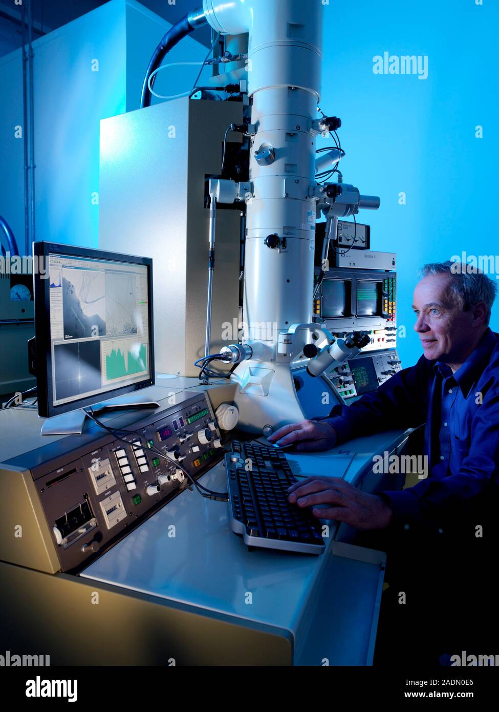 Nanoparticle research. Scientist operating a transmission electron ...