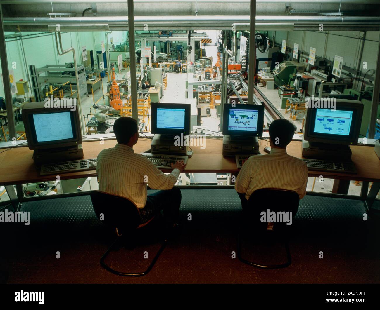 Computer control room. Technicians using computers to control a car ...