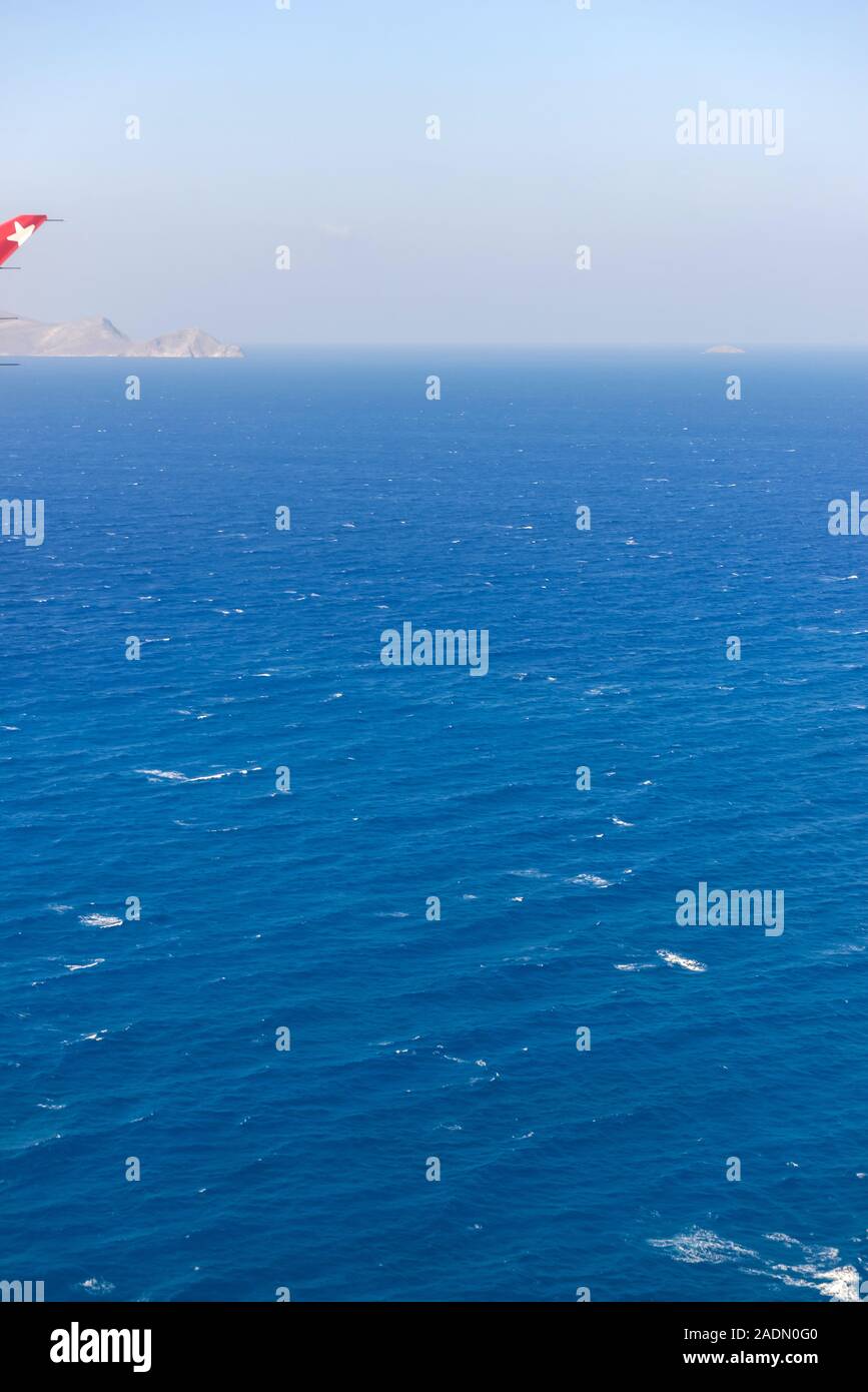 Wing of an airplane flying above the ocean Stock Photo - Alamy