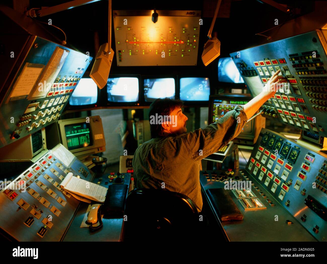 POSED BY MODEL. Computer control room. Technician in a computerised ...
