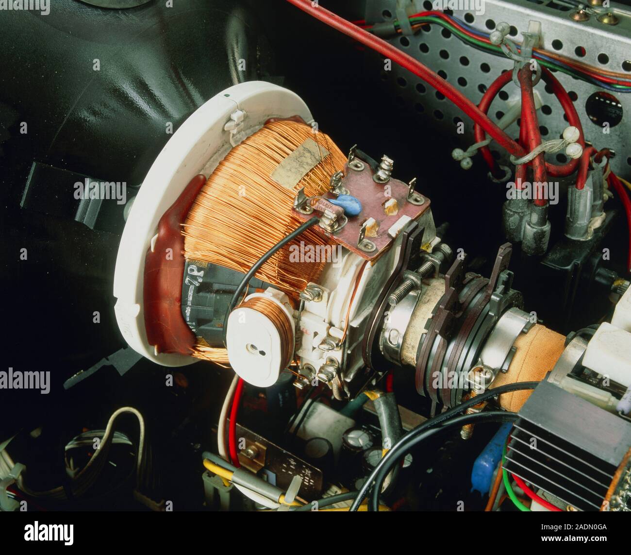 Computer monitor opened to show its cathode ray tube (CRT, centre). The ...