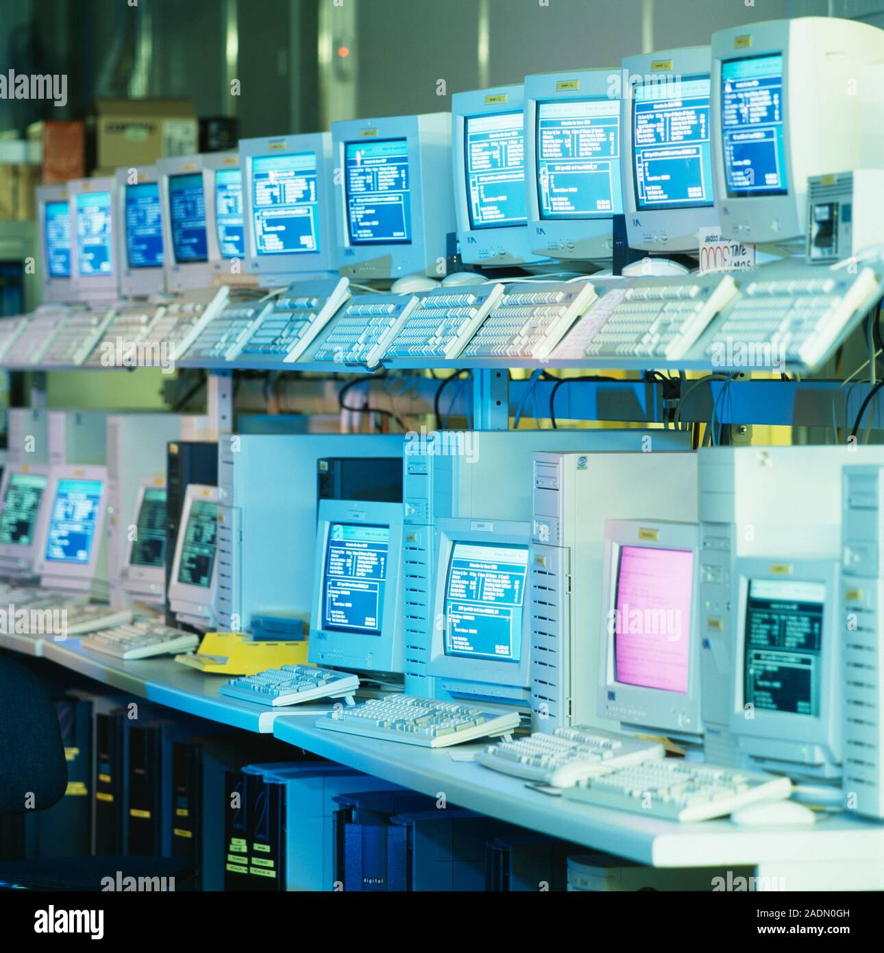 Computer room in a university. Rows of computer monitors, keyboards and vertical processor units ...