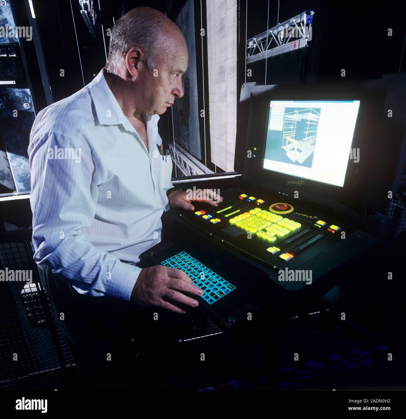 Automated theatre system. Technician setting up an automated theatre ...