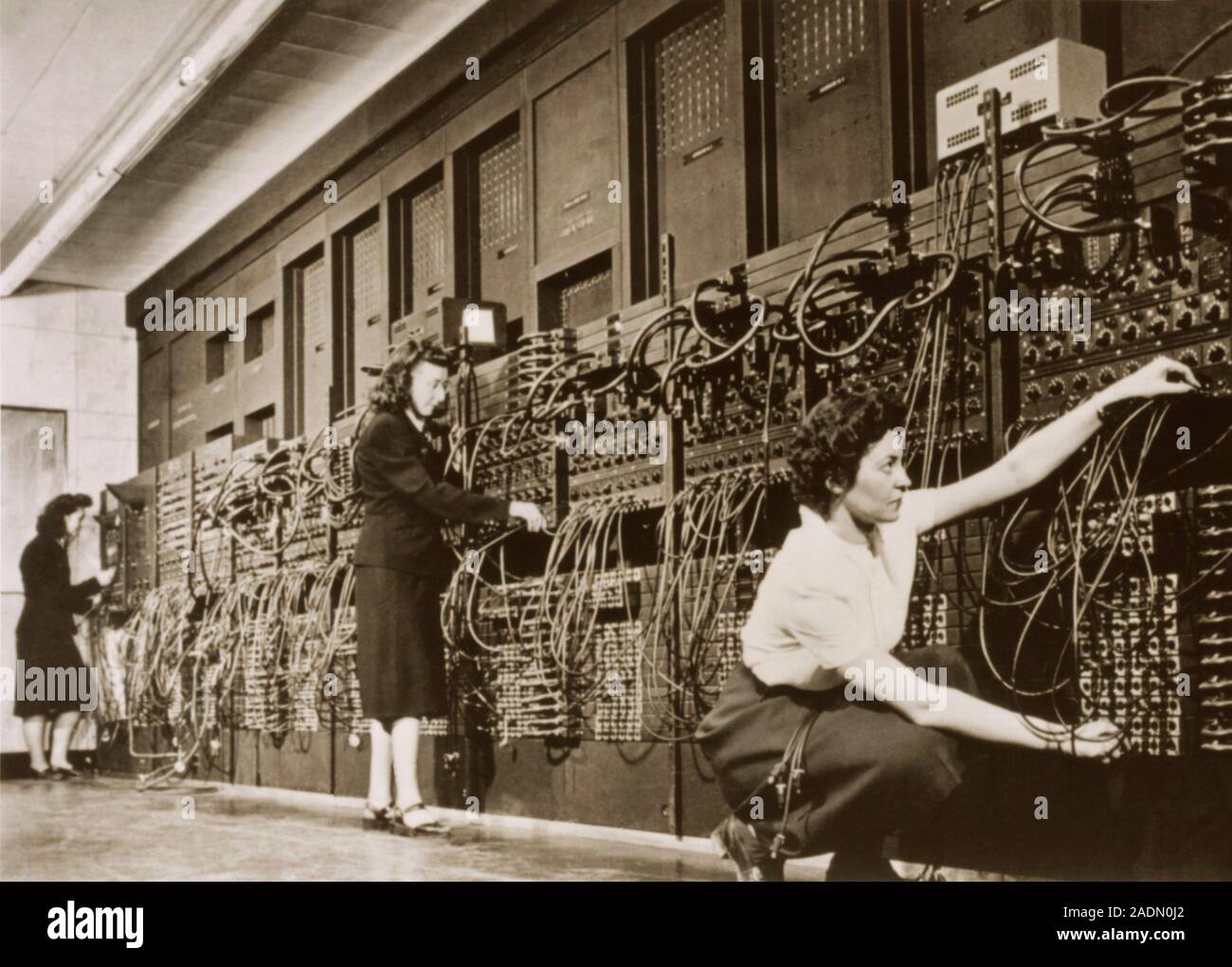 ENIAC digital calculator. Technicians connecting the wiring of the ...