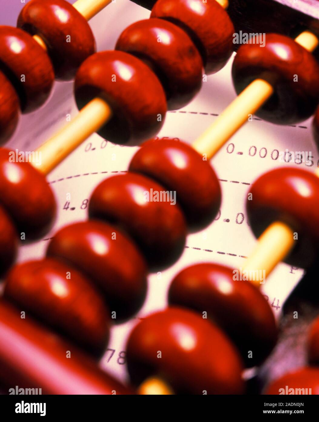 Abacus & computer printout. View of an abacus on a computer printout of ...